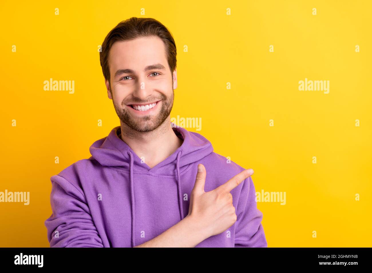 Photo of positive reliable guy direct finger empty space wear violet ...