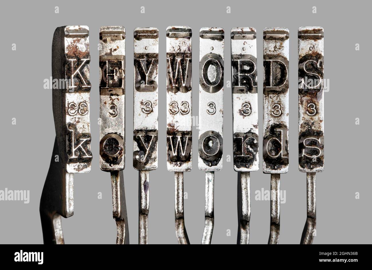 vintage old typewriter hammers with the word keywords Stock Photo - Alamy