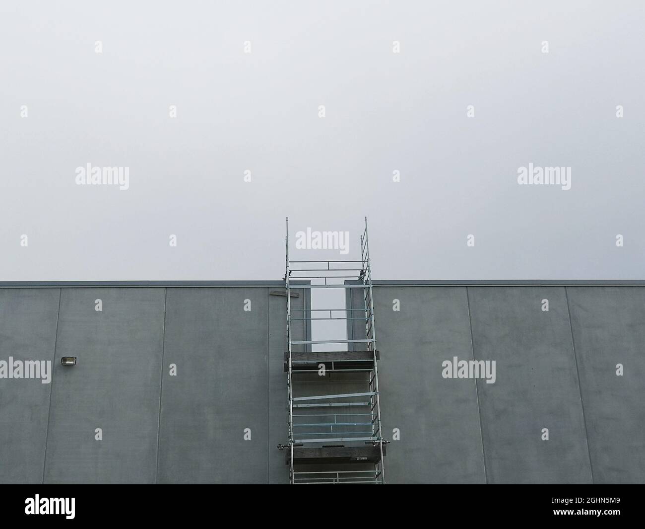 Grayscale shot of an external scaffolding at an industrial warehouse ...