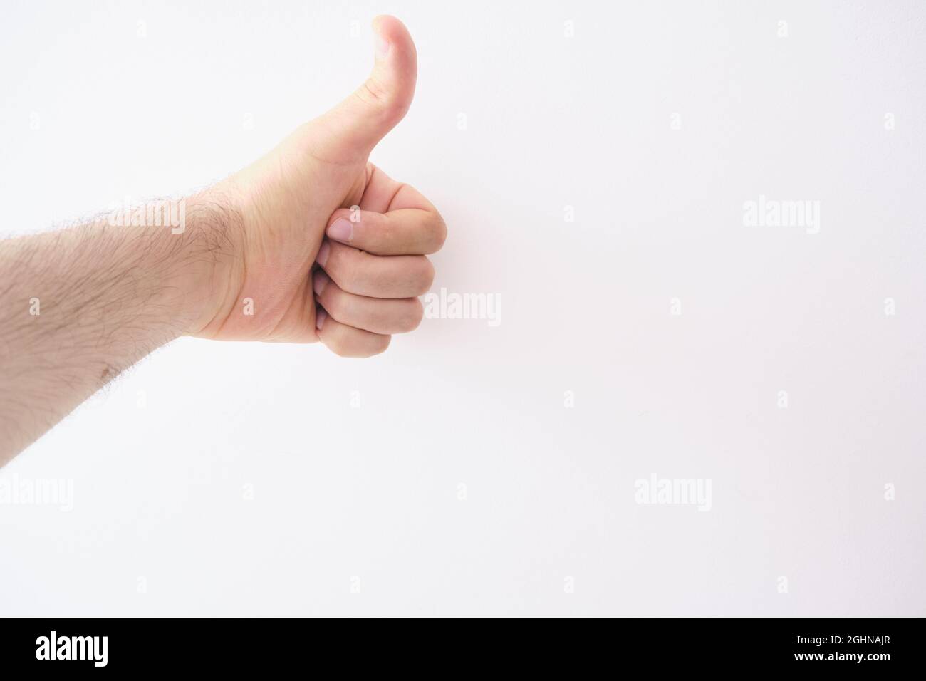 Closeup shot of a hand doing a thumbs-up gesture Stock Photo - Alamy