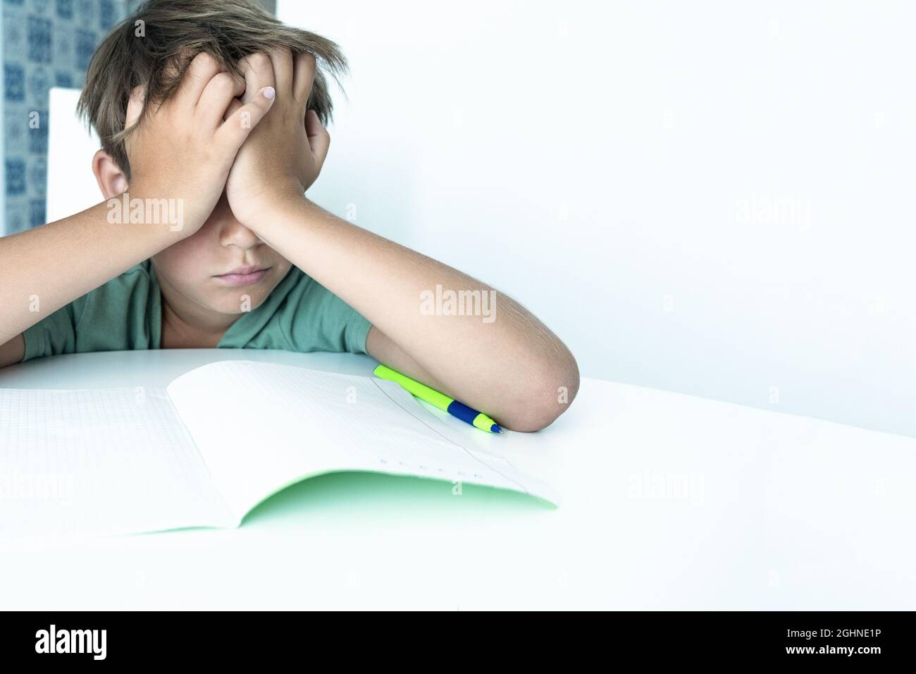 Sad boy with book does school homework. Back to school. Unhappy ...