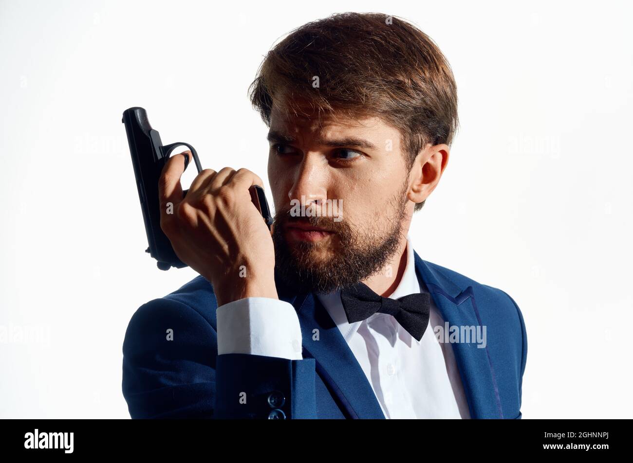 male gangster with a gun in hand Studio emotions Stock Photo - Alamy