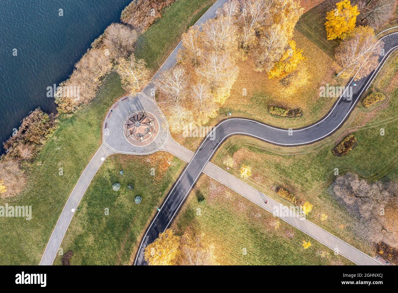 twisted bike lane and walking path on riverbank in city park. beautiful ...