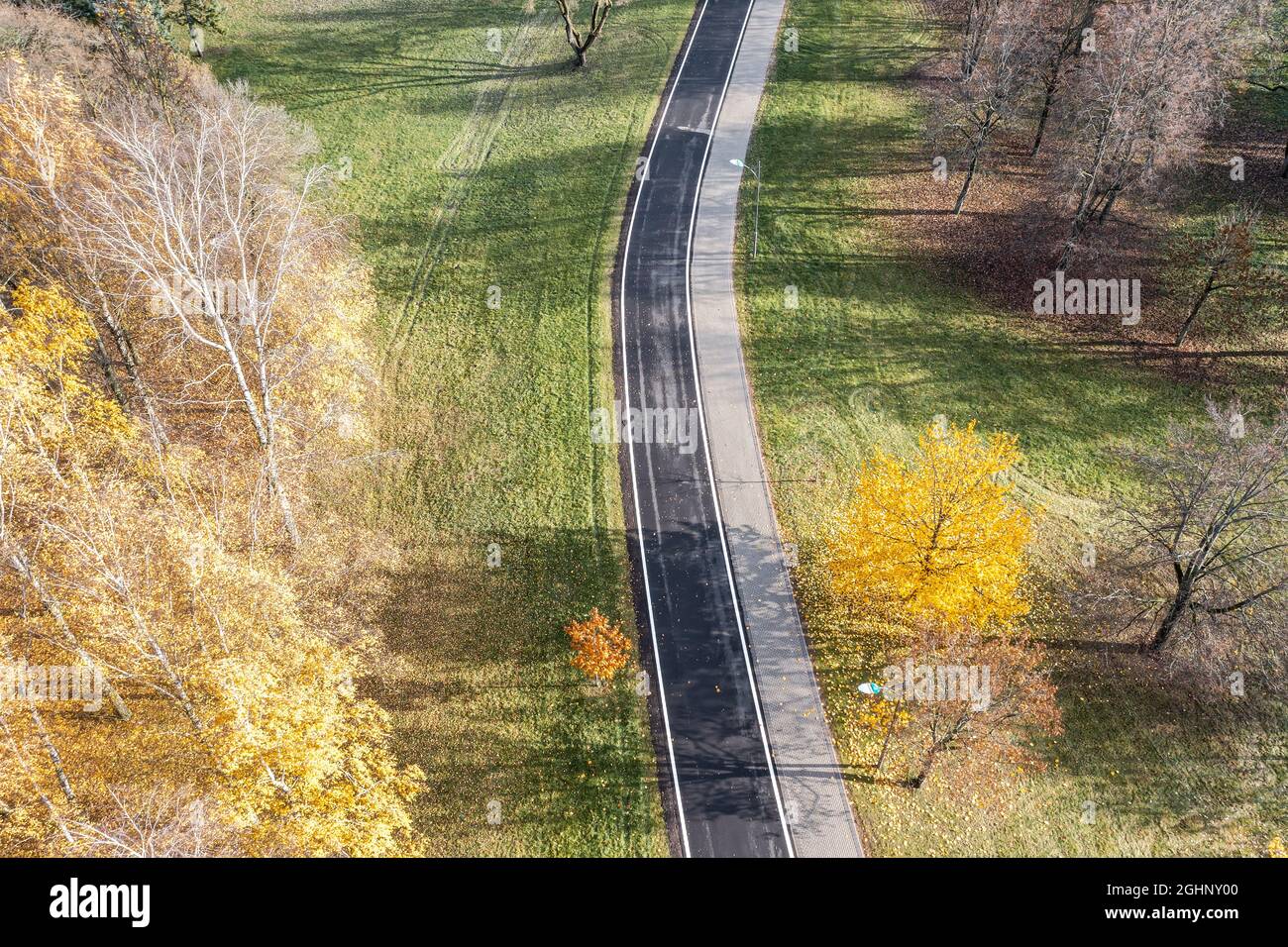 aerial top view of autumn park landscape with runner path and footpath ...