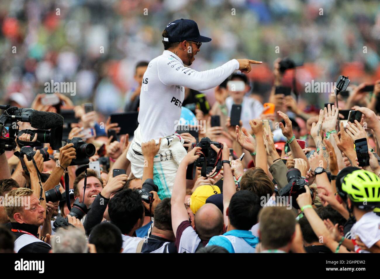 Race winner Lewis Hamilton (GBR) Mercedes AMG F1 crowd surfs with the ...