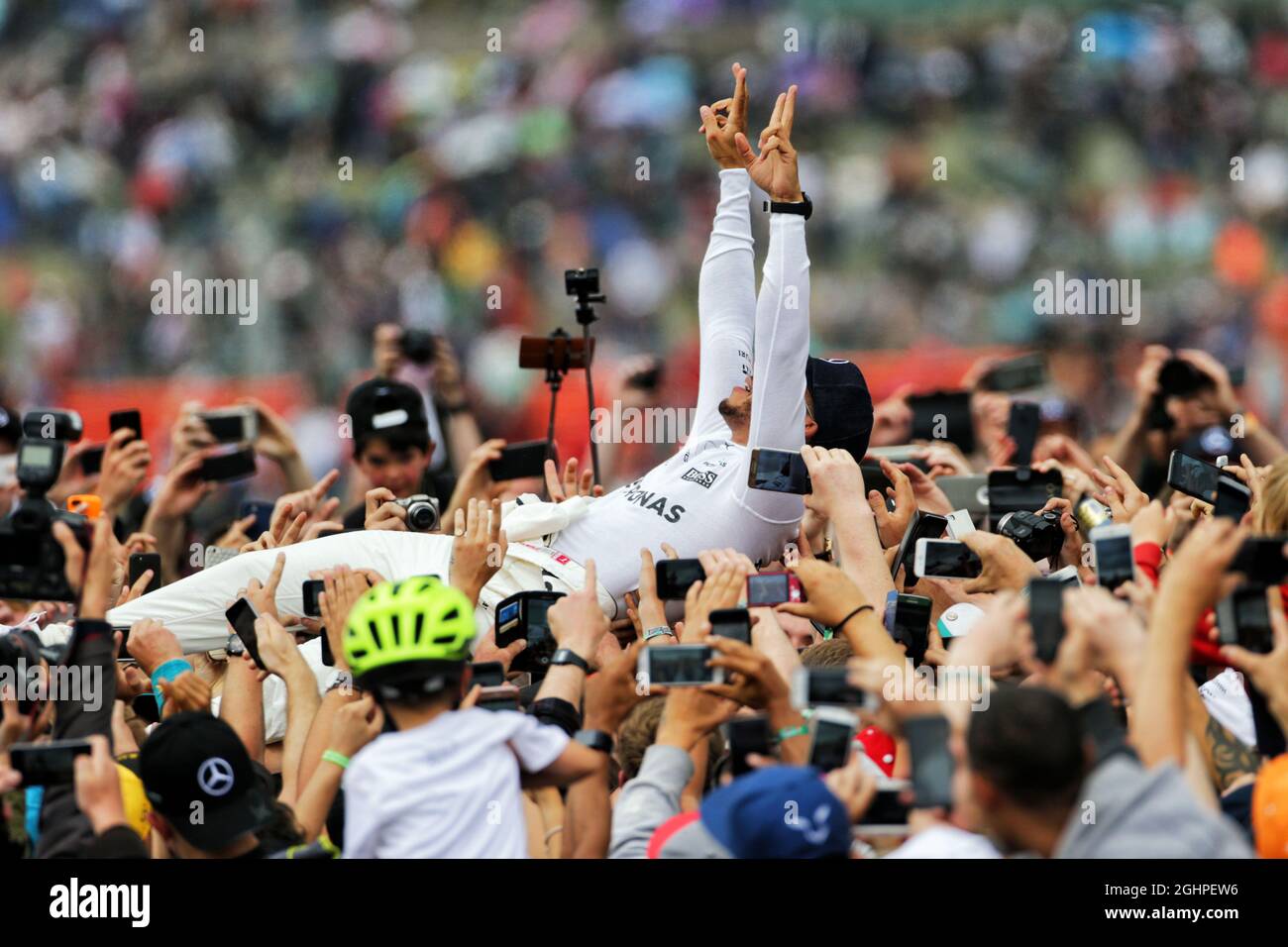 Race winner Lewis Hamilton (GBR) Mercedes AMG F1 crowd surfs with the ...