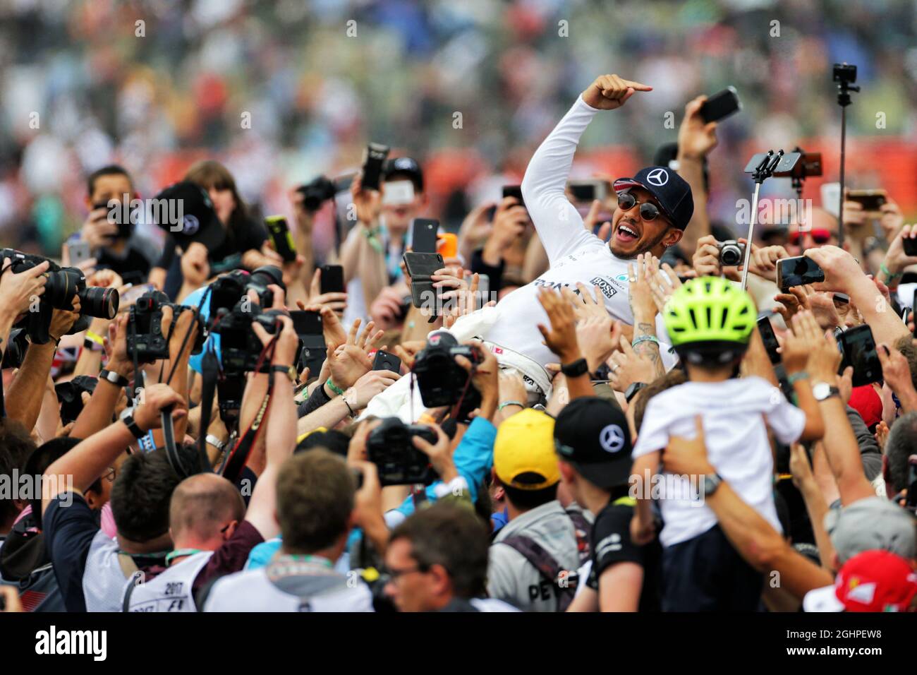 Race winner Lewis Hamilton (GBR) Mercedes AMG F1 crowd surfs with the ...