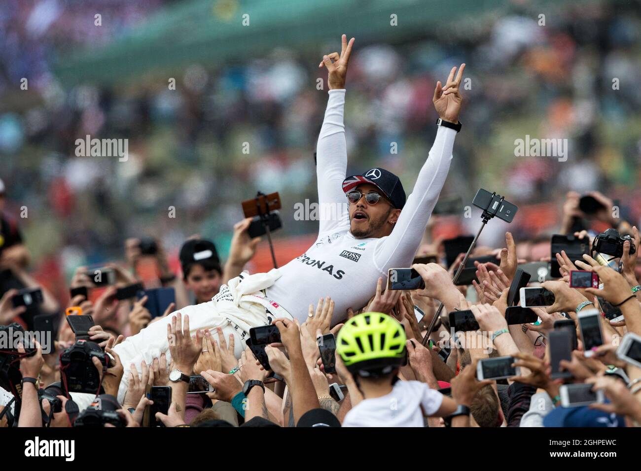 Race winner Lewis Hamilton (GBR) Mercedes AMG F1 crowd surfs with the ...