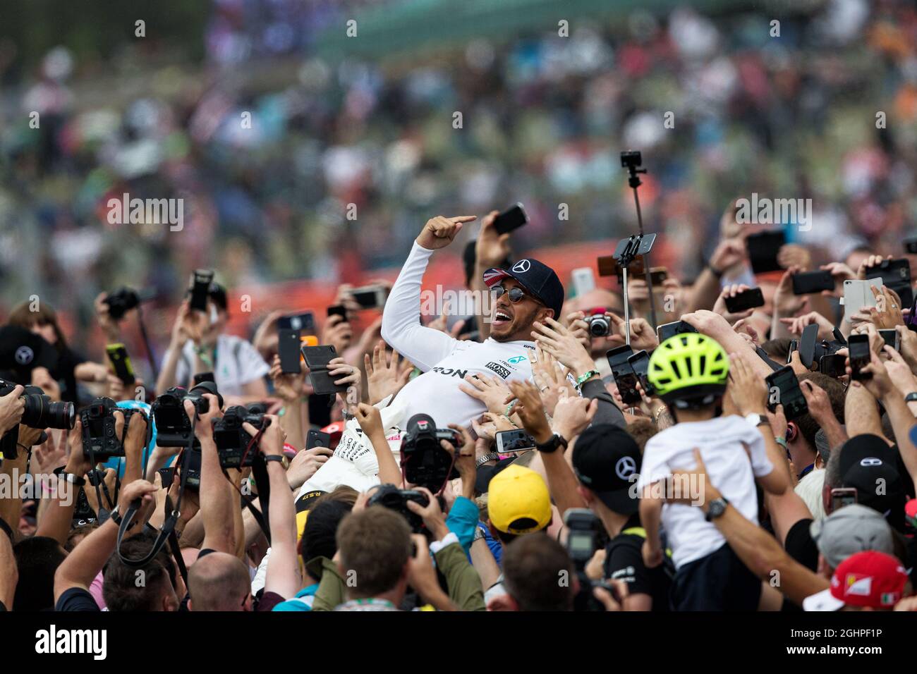 Race winner Lewis Hamilton (GBR) Mercedes AMG F1 crowd surfs with the ...