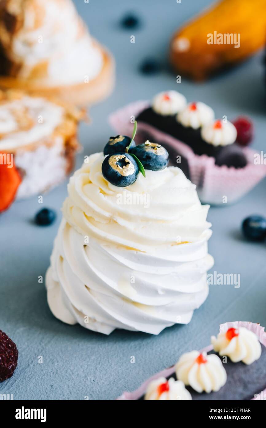 Dessert Anna Pavlova with meringue and cheese cream inside, decorated ...