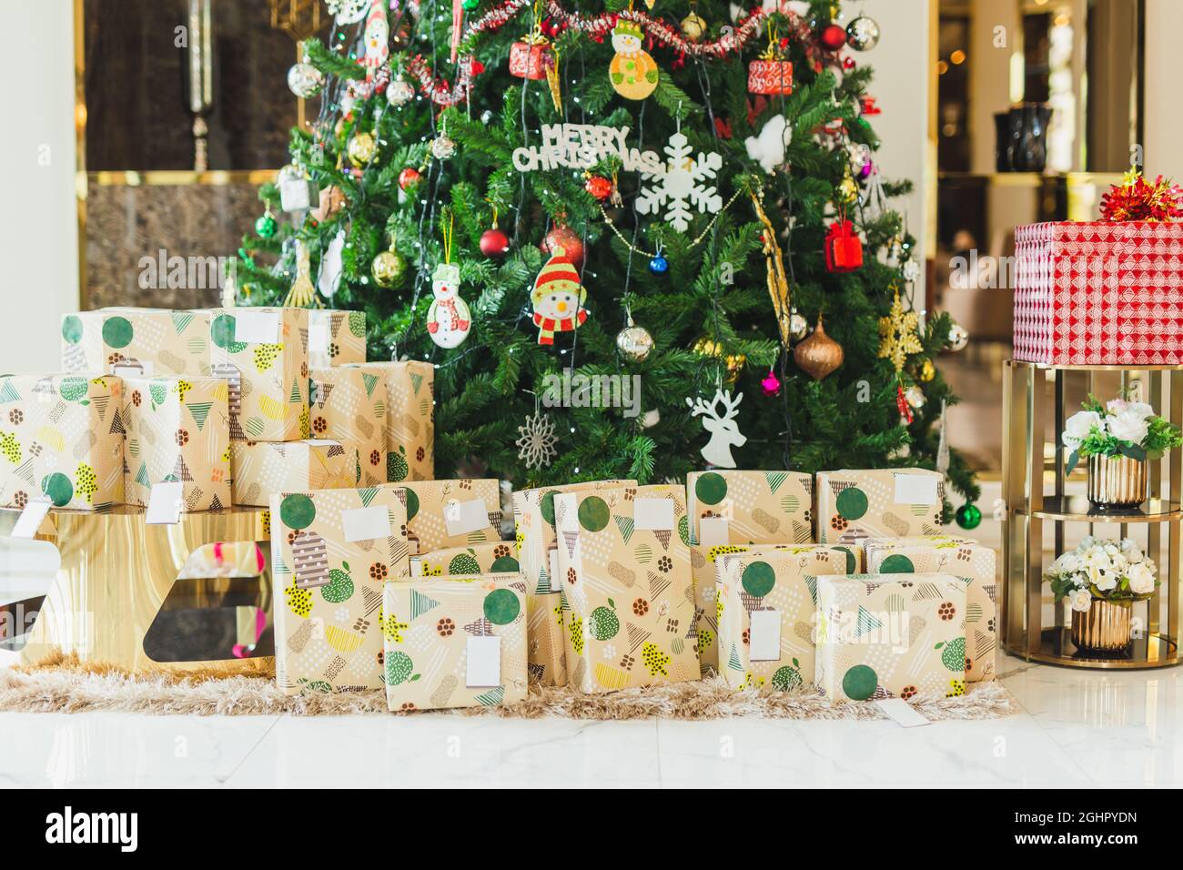 Boxes decorated with Christmas gifts under a Christmas tree at home ...