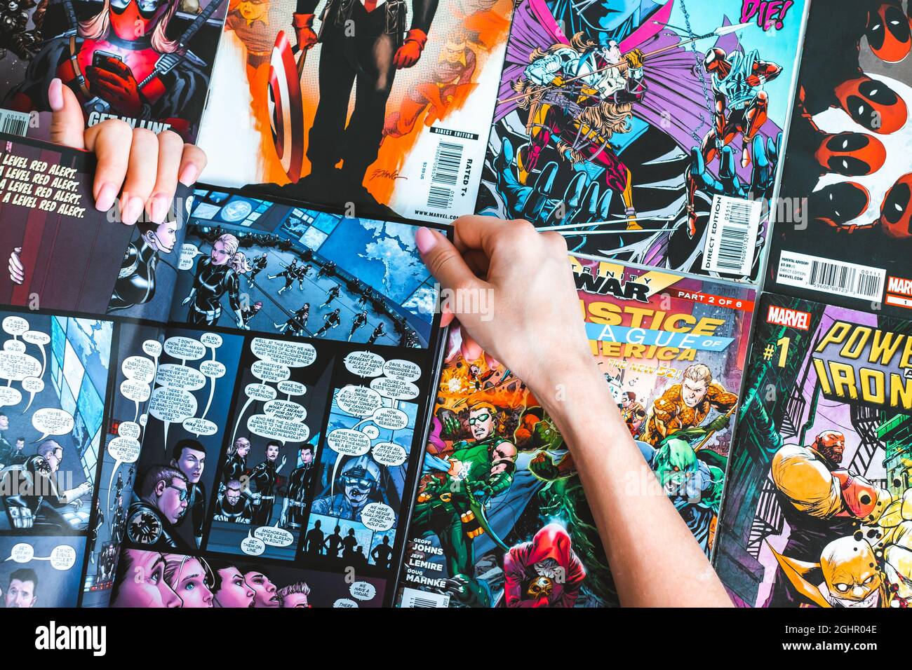 Reading comic books, hand flipping pages Stock Photo - Alamy