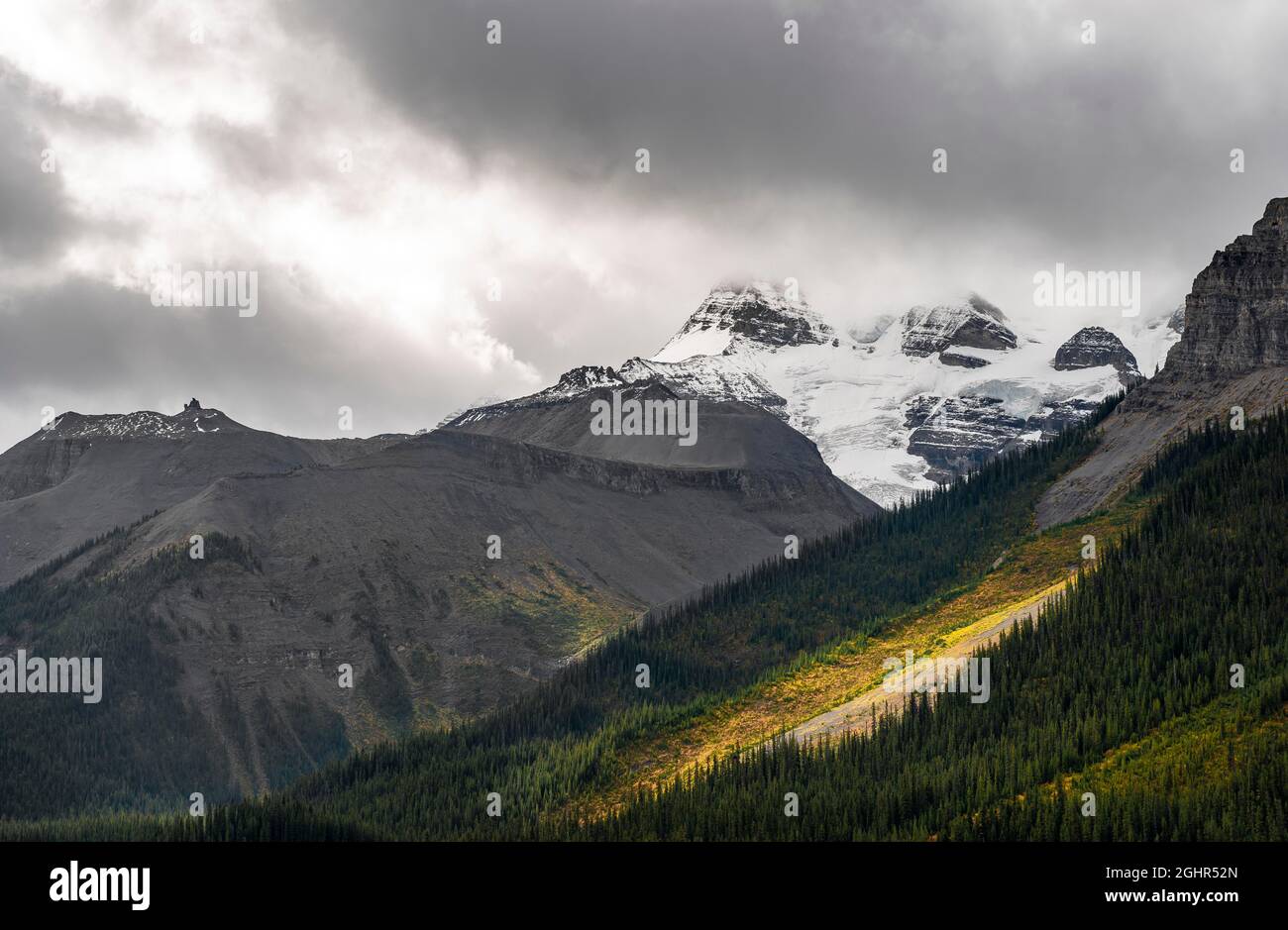 Cloudy snow-capped peaks, Mount Charlton and Mount Unwin, autumnal ...