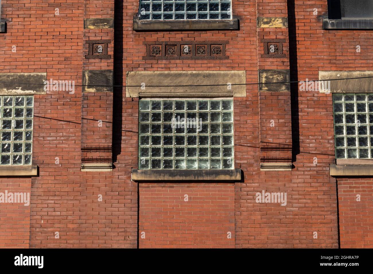 Facade of an old red brick commercial industrial building, decorative ...