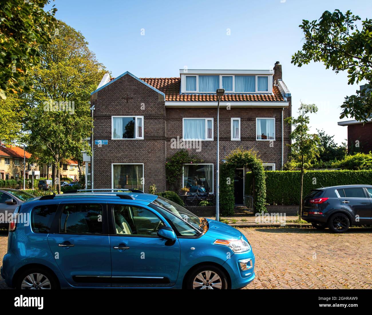 Beautiful dutch architecture in the heart of Haarlem with parked cars ...