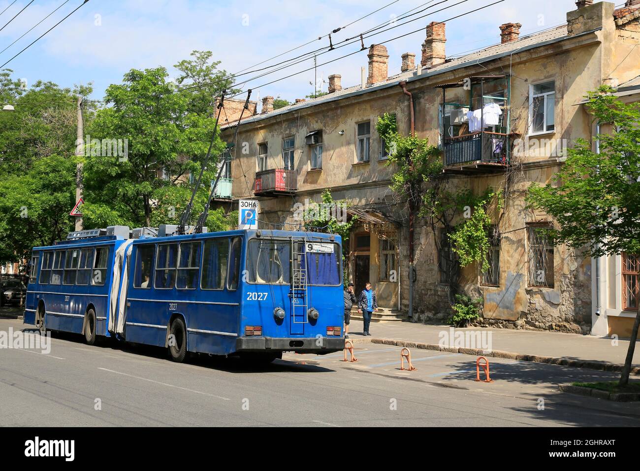 Trolleybus and house facade in need of renovation in Primorski district ...