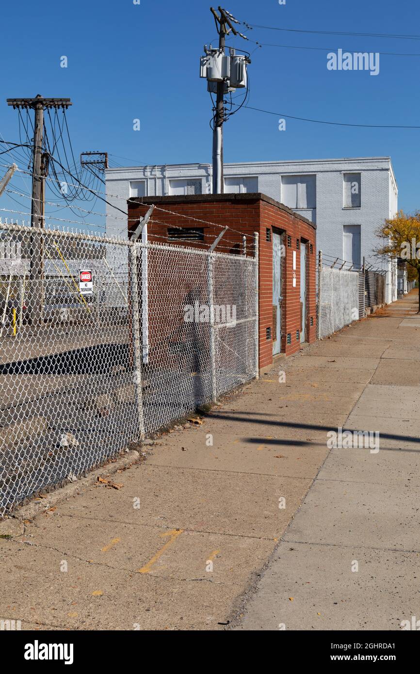 Sidewalk alongside a commercial industrial facility, newer chain link ...