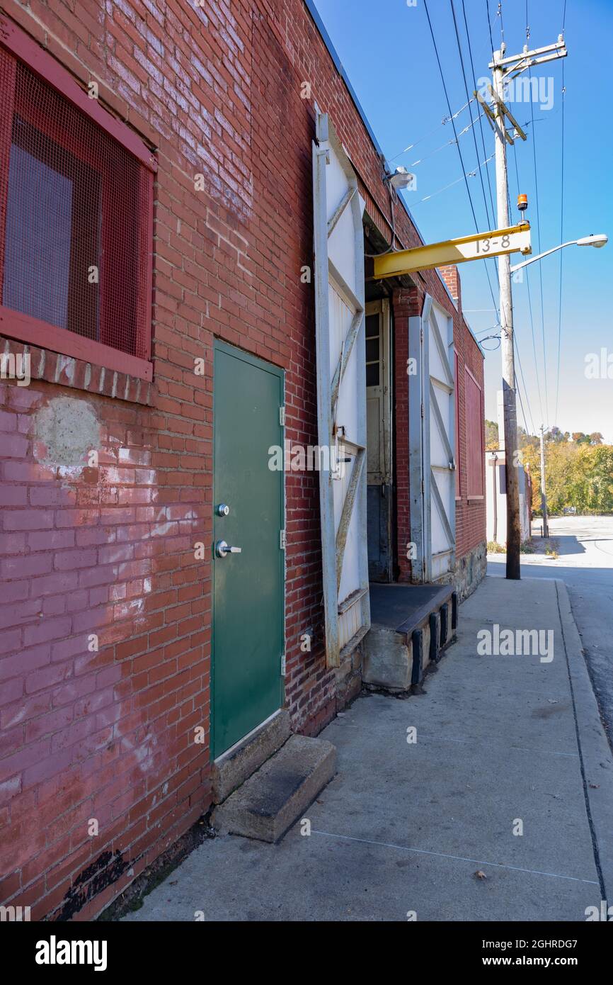 Sidewalk and facade of an old red brick commercial building, loading ...