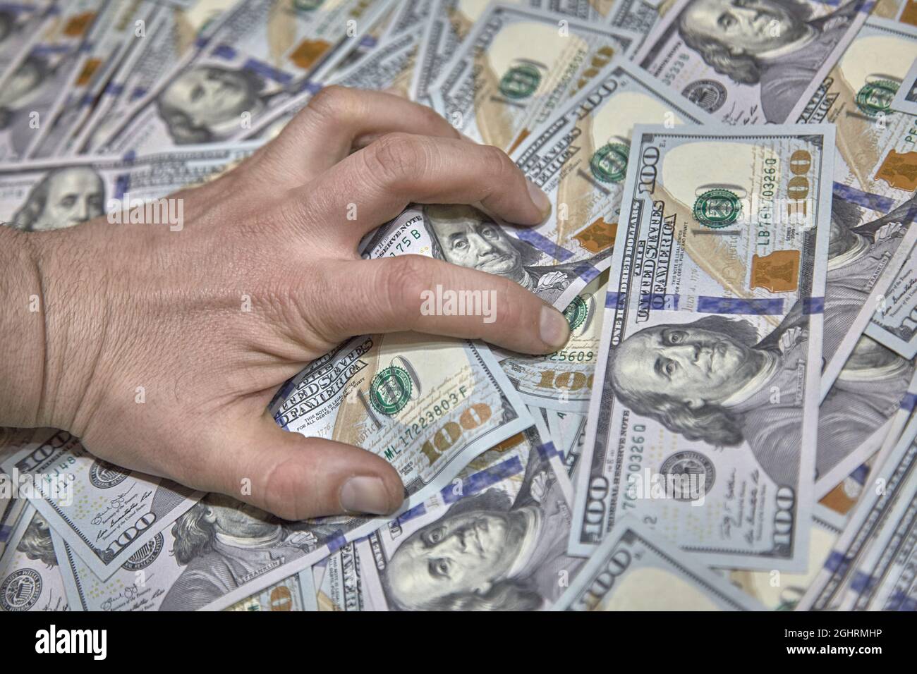 hand clutching money, the concept of greed Stock Photo - Alamy