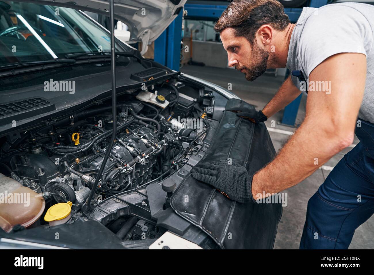 Mechanic examining engine component hi-res stock photography and images ...