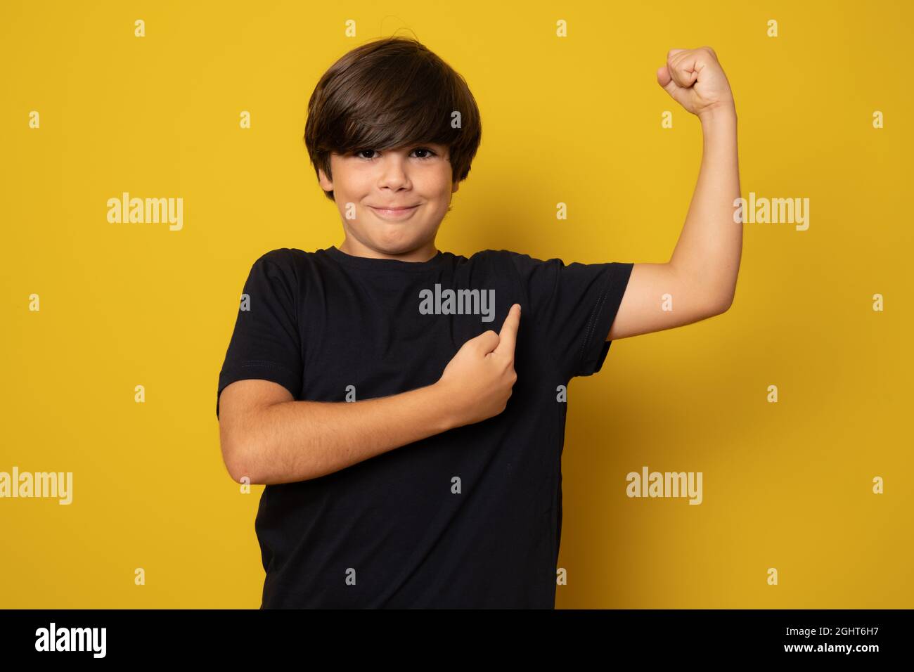 Little but strong. Confident child boy showing his biceps isolated over ...
