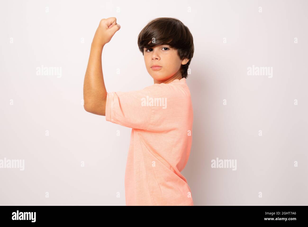 Little but strong. Confident child boy showing his biceps isolated over ...