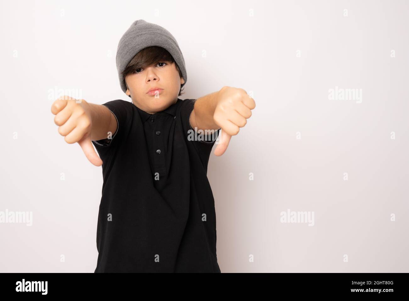 Close up emotional portrait of caucasian unhappy teen boy giving thumbs ...