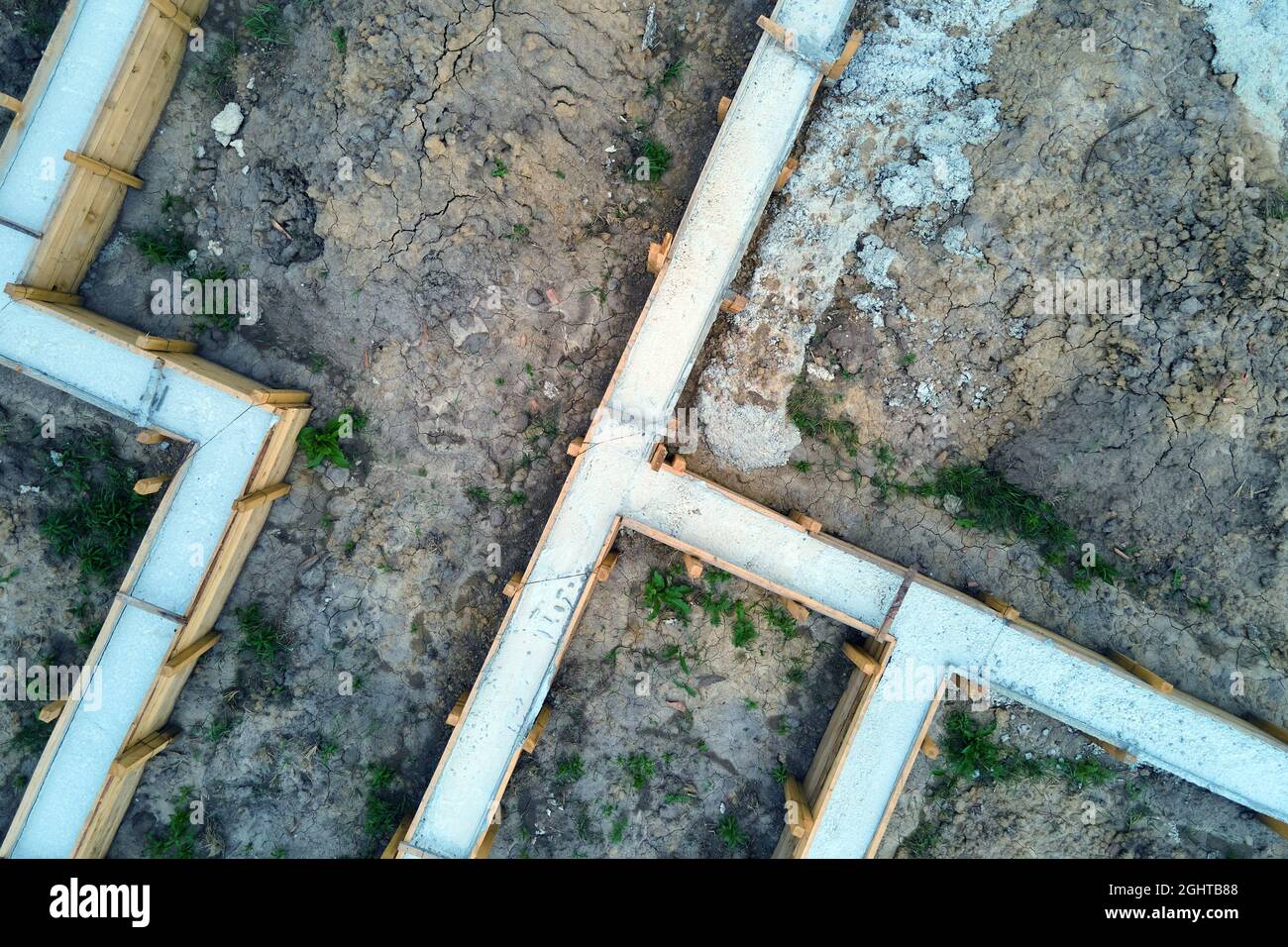Top down aerial view of building works of new house concrete foundation ...