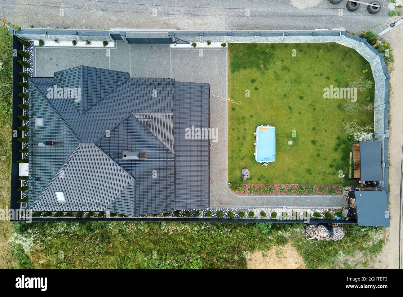 Aerial view of private house with green backyard and small swimming ...