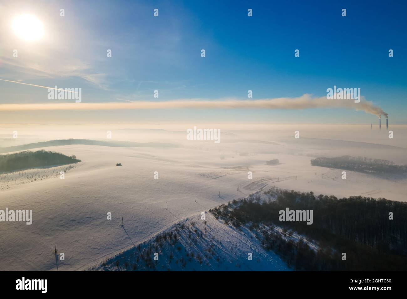 Aerial view of winter landscape with foggy countryside and distant ...