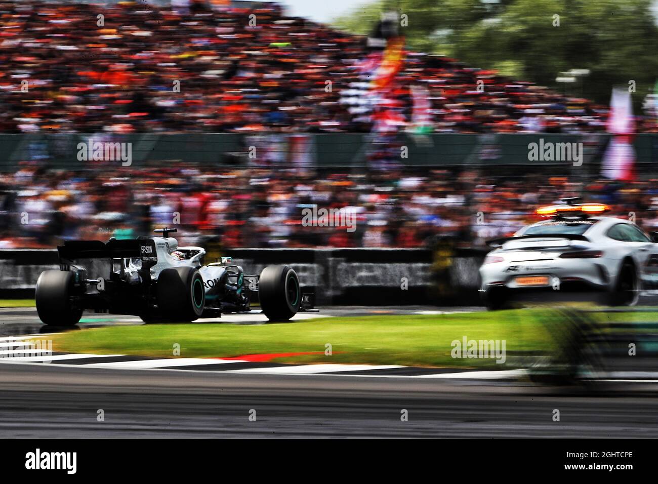 Lewis Hamilton (GBR) Mercedes AMG F1 W10 leads behind the FIA Safety ...