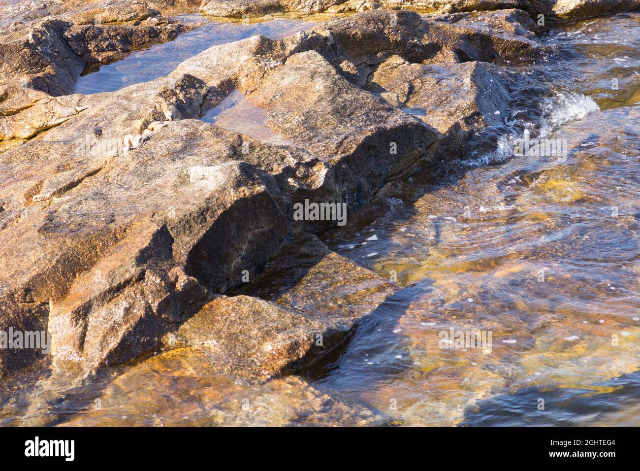 Dark stones and clear sea water. Stones and rocks without shape Stock ...