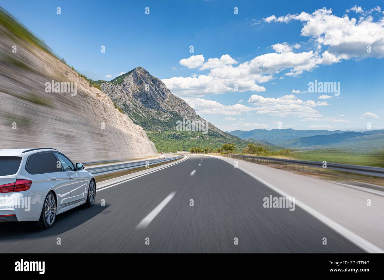 Car is driving along the road. White car on a suburban highway Stock ...