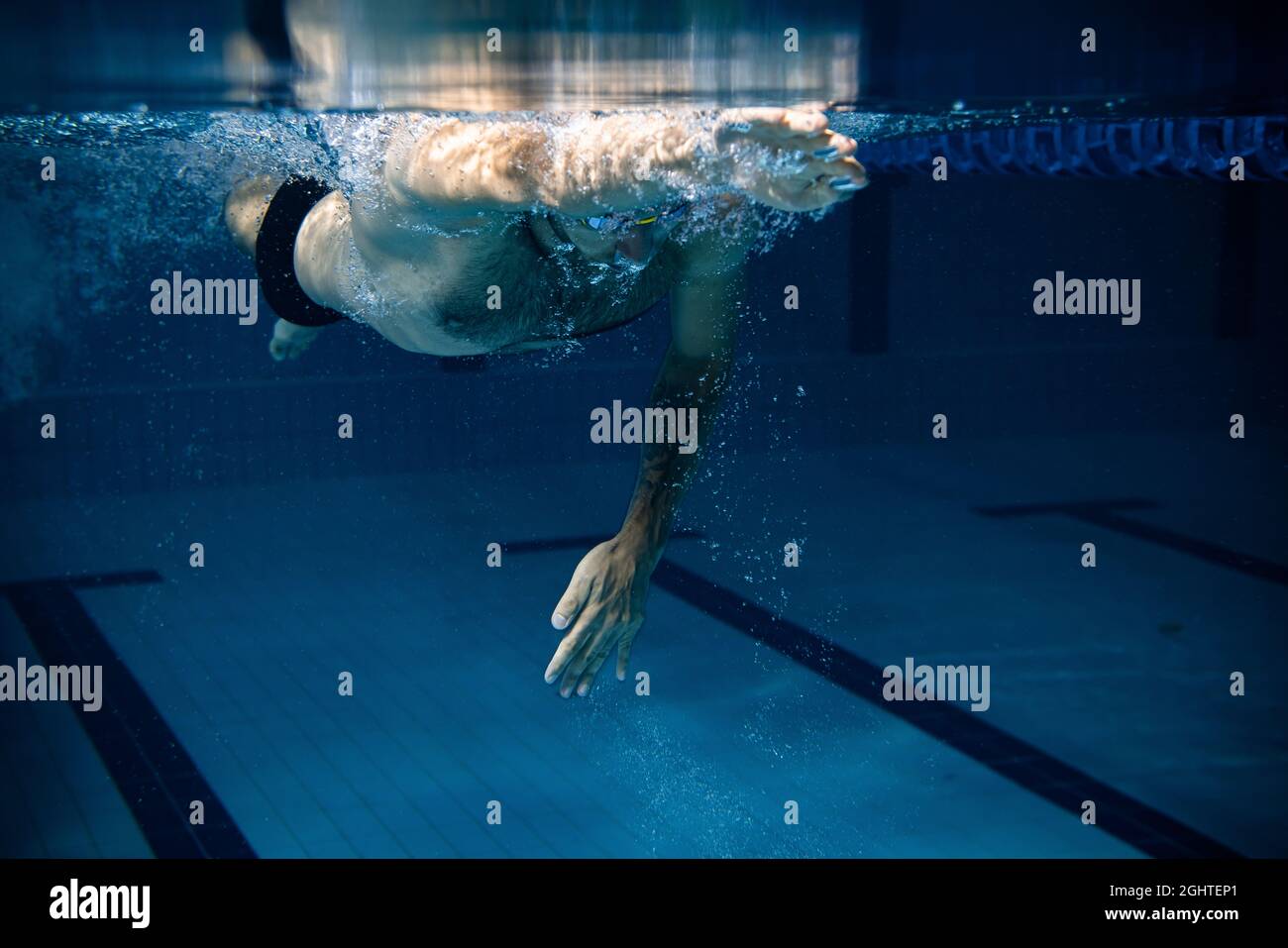 Underwater view of professional male swimmer in motion and action ...