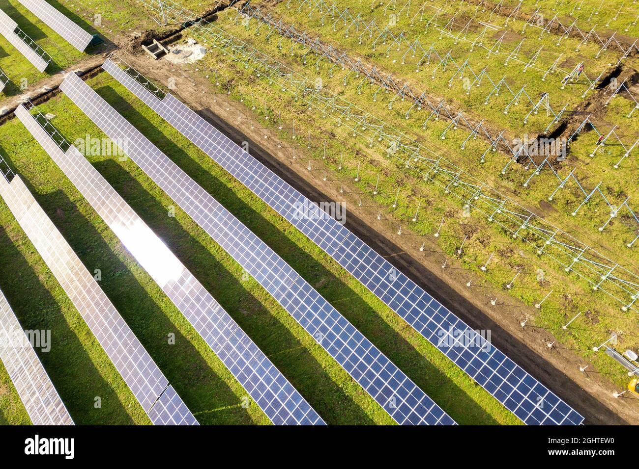 Aerial view of solar power plant under construction on green field ...