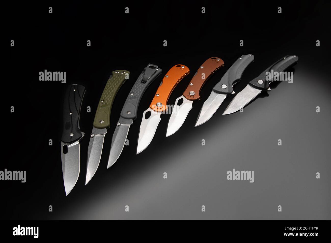 Various folding pocket knives on a dark background. A versatile pocket ...