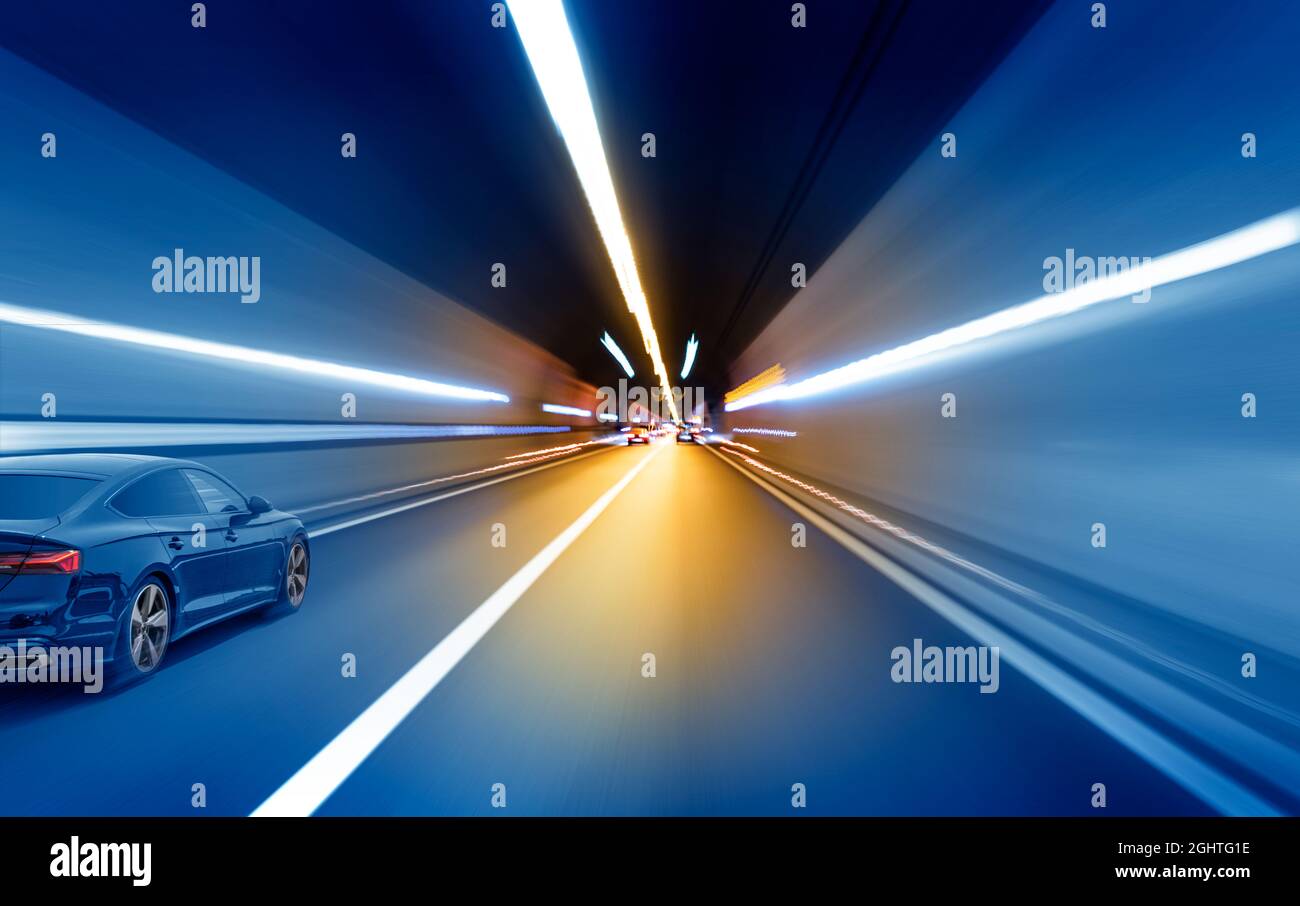 Cars rush through the tunnel in the beams of searchlights Stock Photo ...