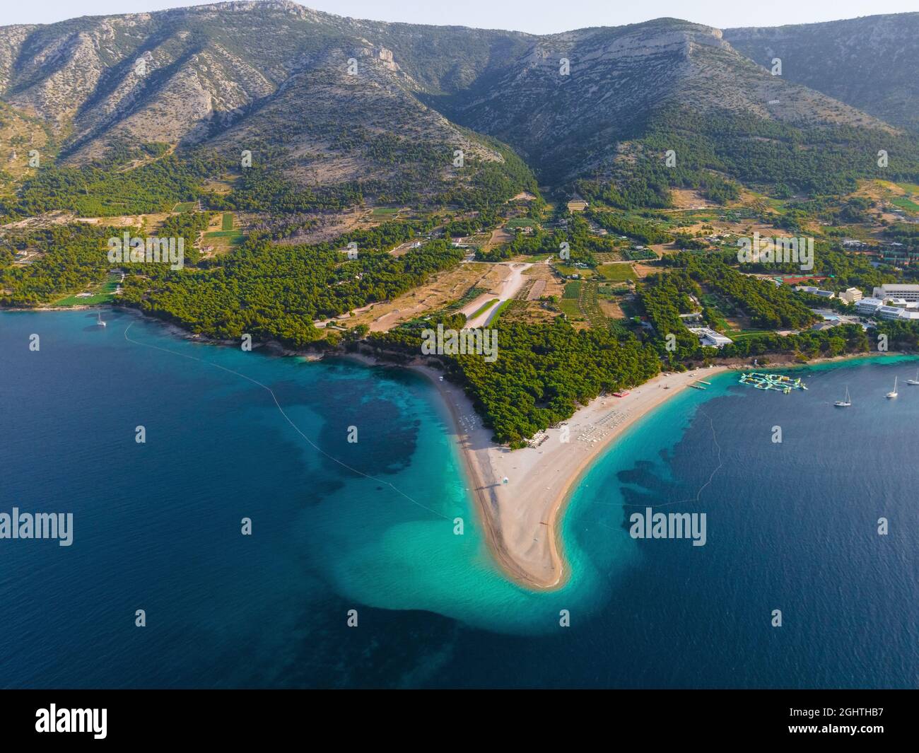 Aerial view of the Zlatni Rat sandy beach, sea and mountains on Brac ...
