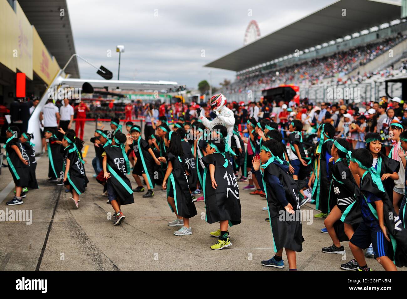 Circuit atmosphere - Young Mercedes AMG F1 fans dance in the pit lane ...