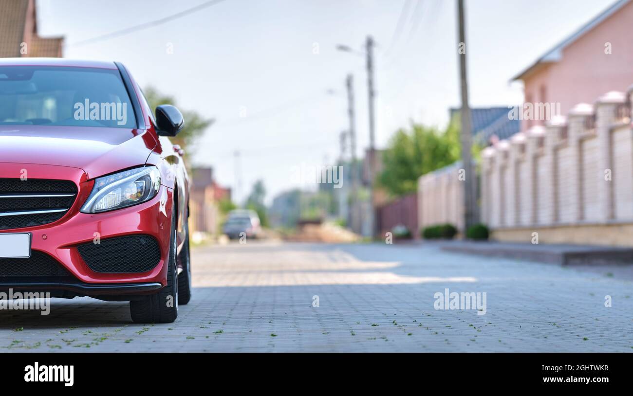 Front view of new car parked on city street side Stock Photo - Alamy