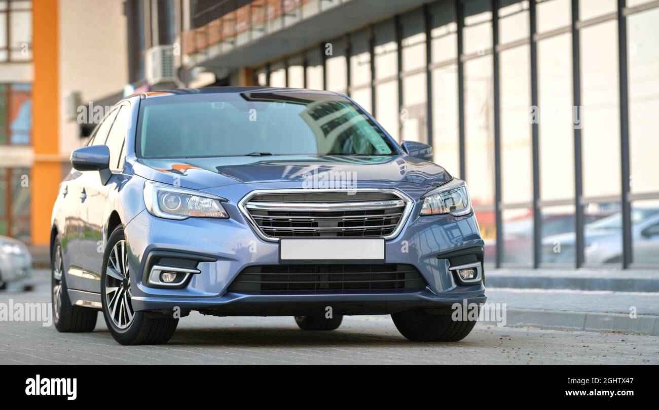 Closeup view of new shiny expensive car parked on city street side ...