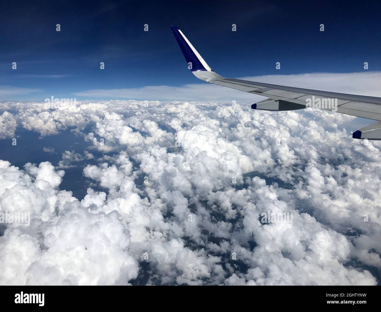 Aircraft wing in flight over clouds Stock Photo - Alamy