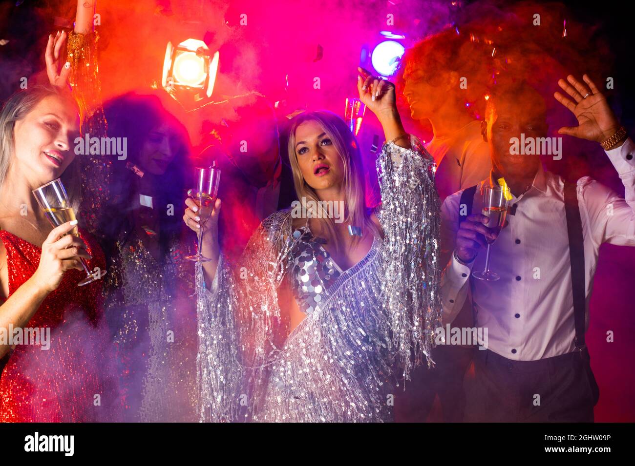 Group people with champagne dancing at party Stock Photo - Alamy