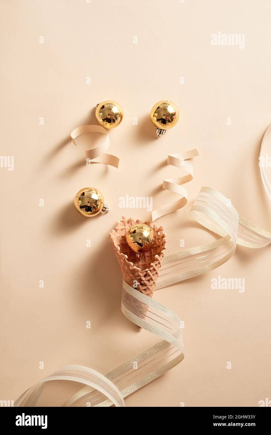 Ice cream waffle cone with ribbon and balls ornament topping. Skin ...
