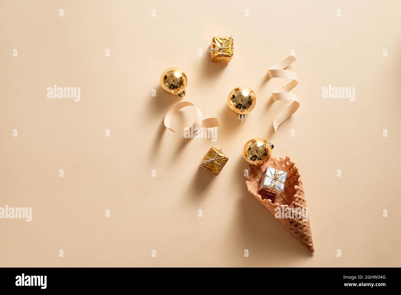Ice cream waffle cone with ribbon and balls ornament topping. Skin ...