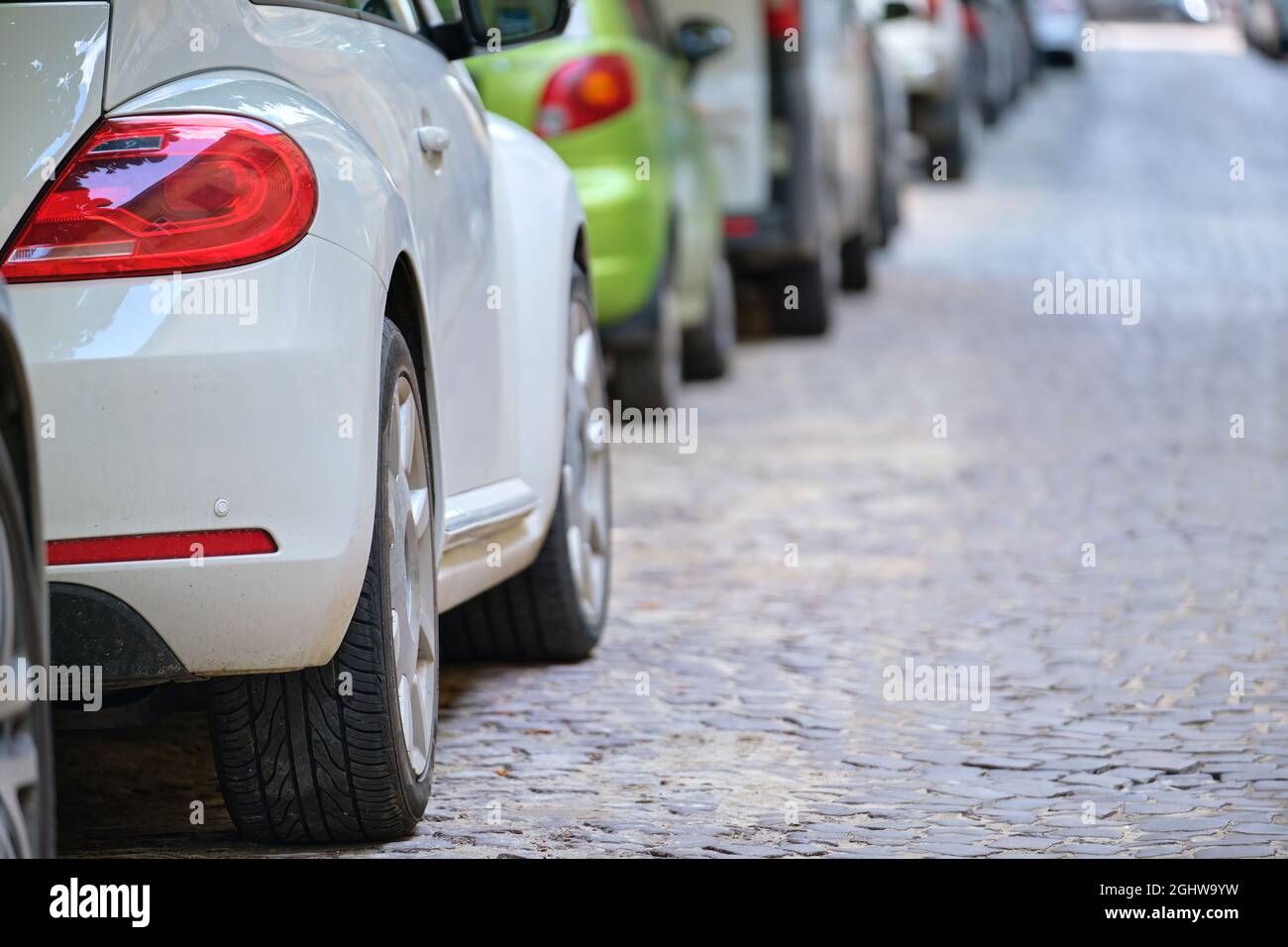 City traffic with cars parked in line on street side Stock Photo - Alamy