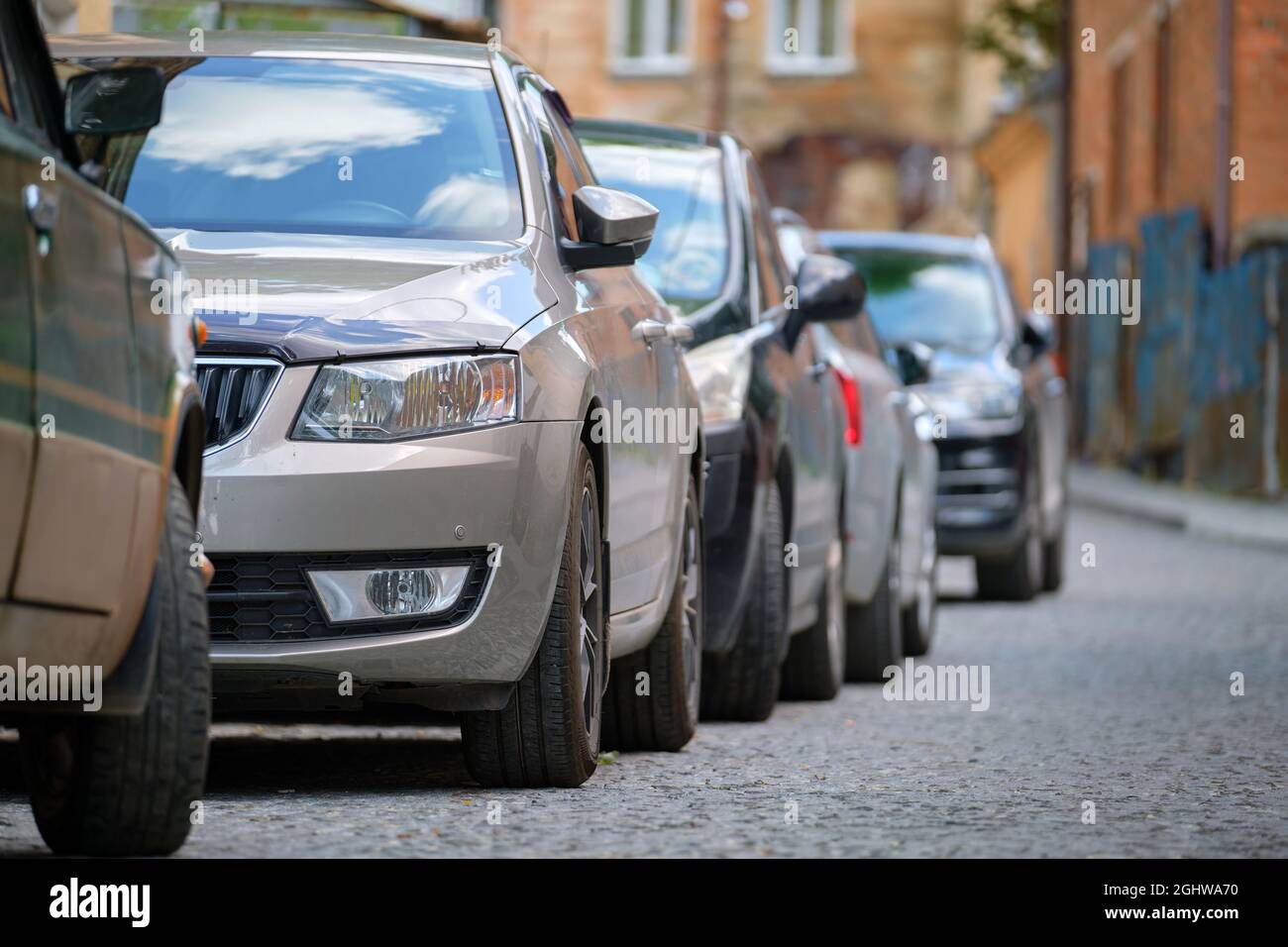 City traffic with cars parked in line on street side Stock Photo - Alamy
