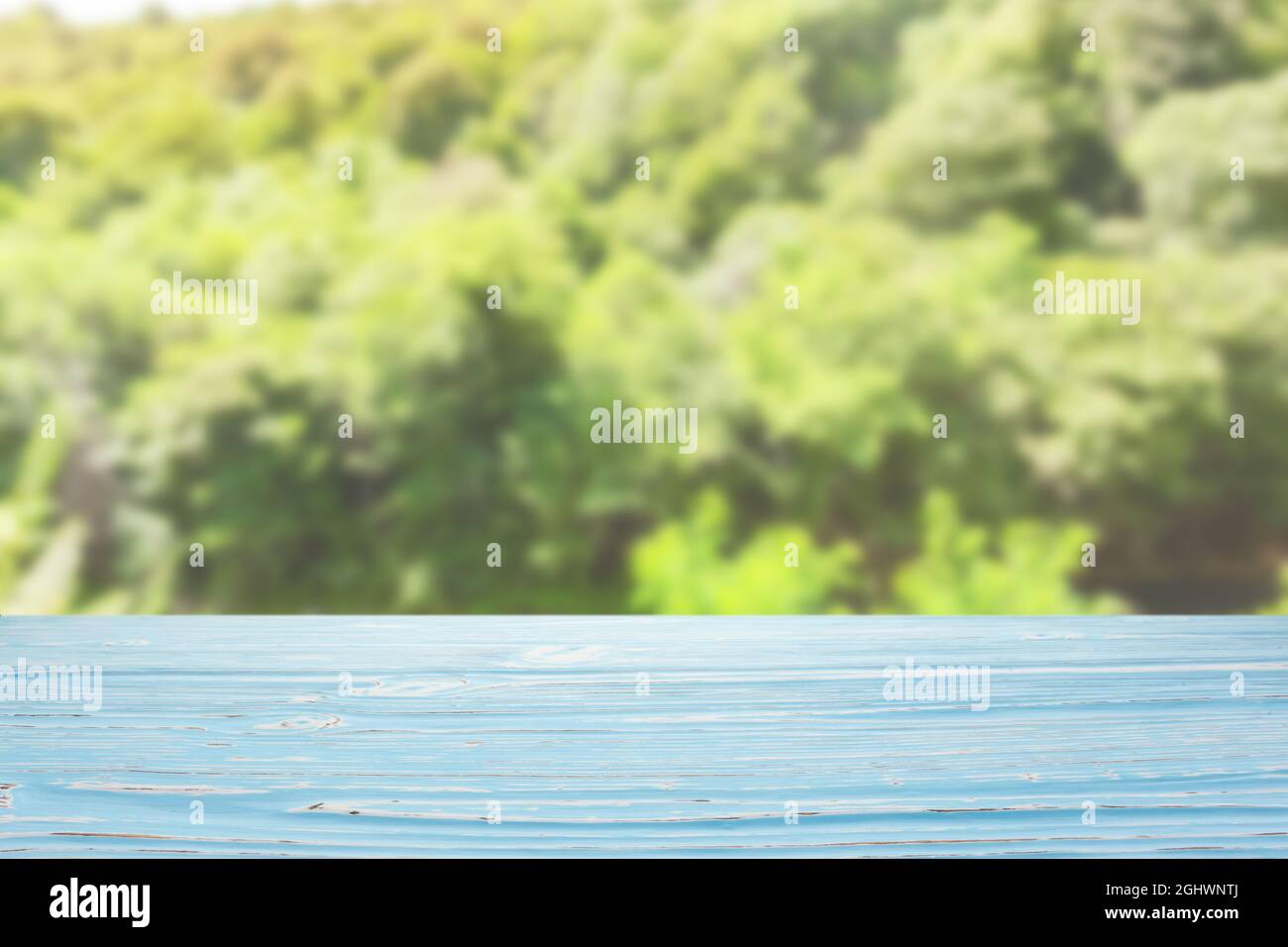 blue wood table top on blur tree and green foliage background Stock ...