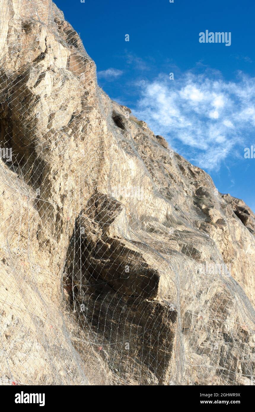 metal mesh on the mountain to prevent rockslide on the road Stock Photo ...