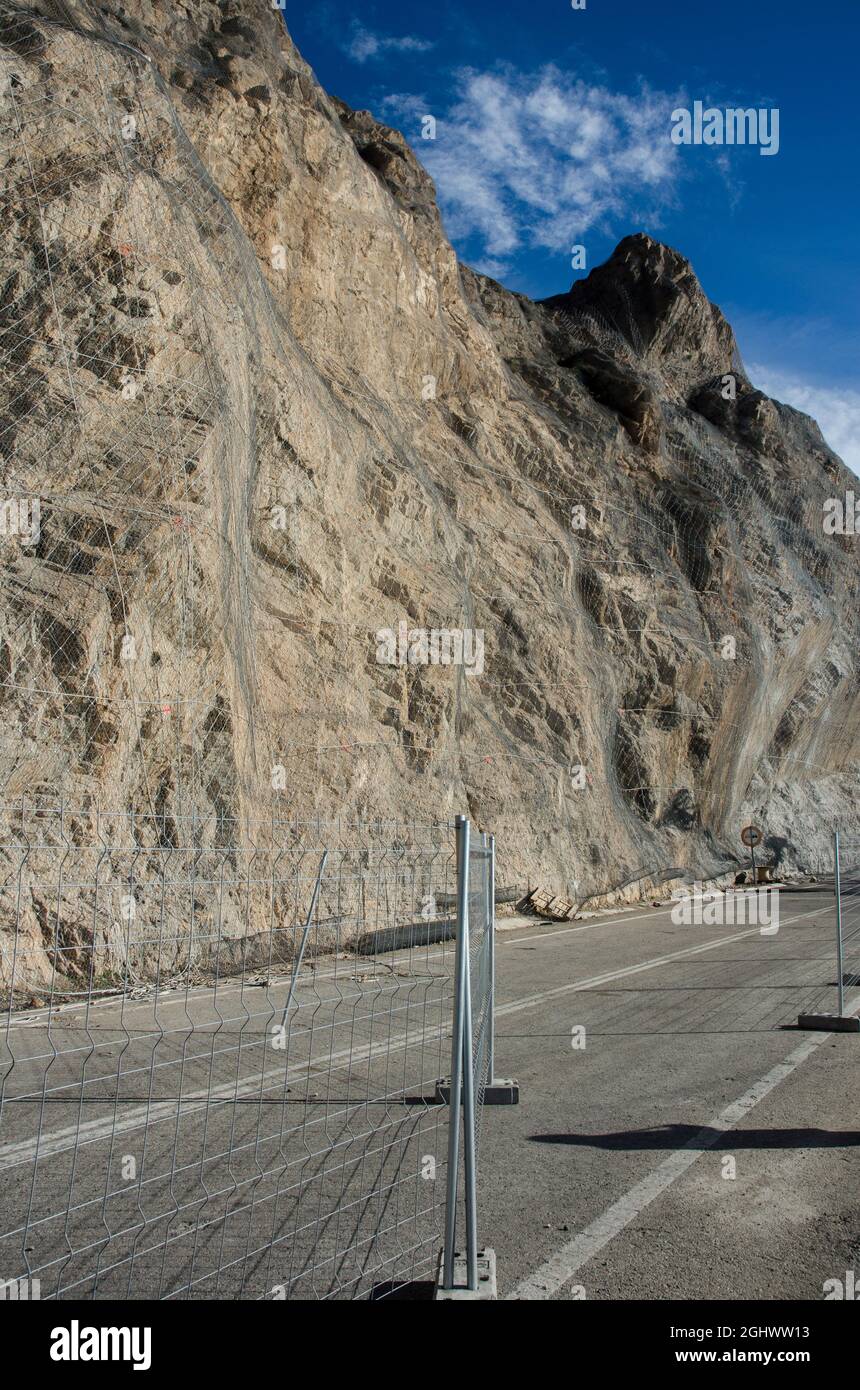 metal mesh on the mountain to prevent rockslide on the road Stock Photo ...
